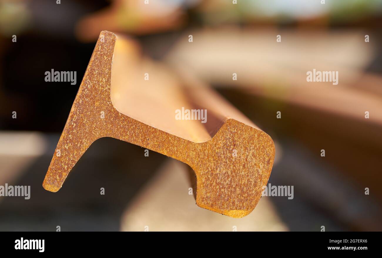 Close up of the cross section of a rusty railroad rail in a storage ...