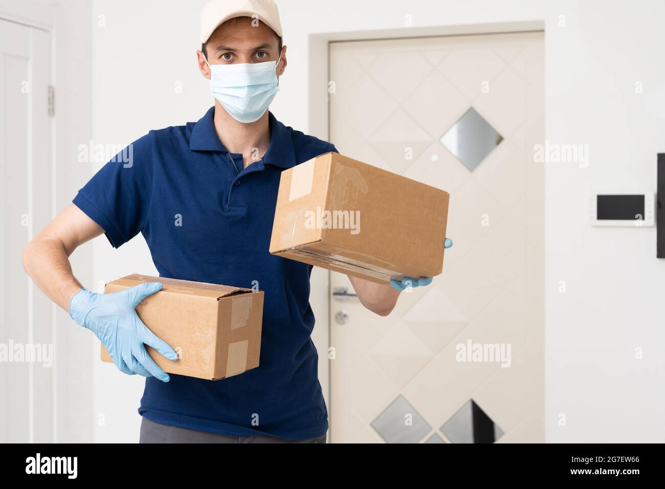 handsome young delivery man portrait on white Stock Photo - Alamy