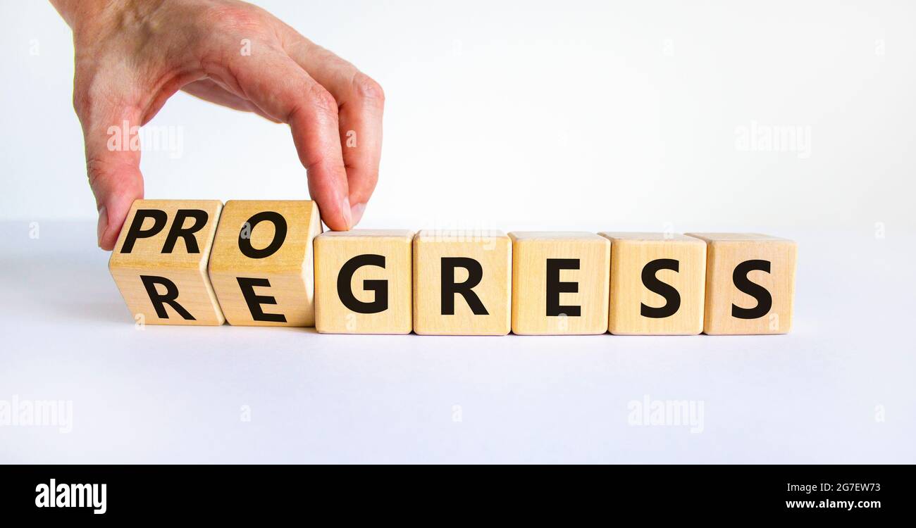Regress or progress symbol. Businessman turns wooden cubes and changes ...