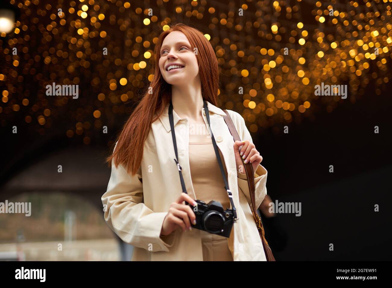 Woman camera backpack stands hi-res stock photography and images - Alamy