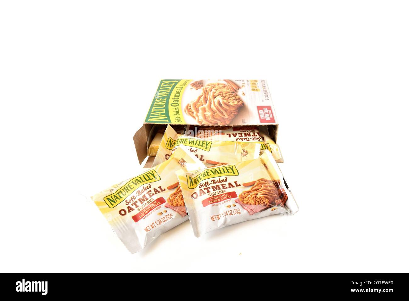 Nature Valley Oatmeal Squares spilling out of the box on a white ...