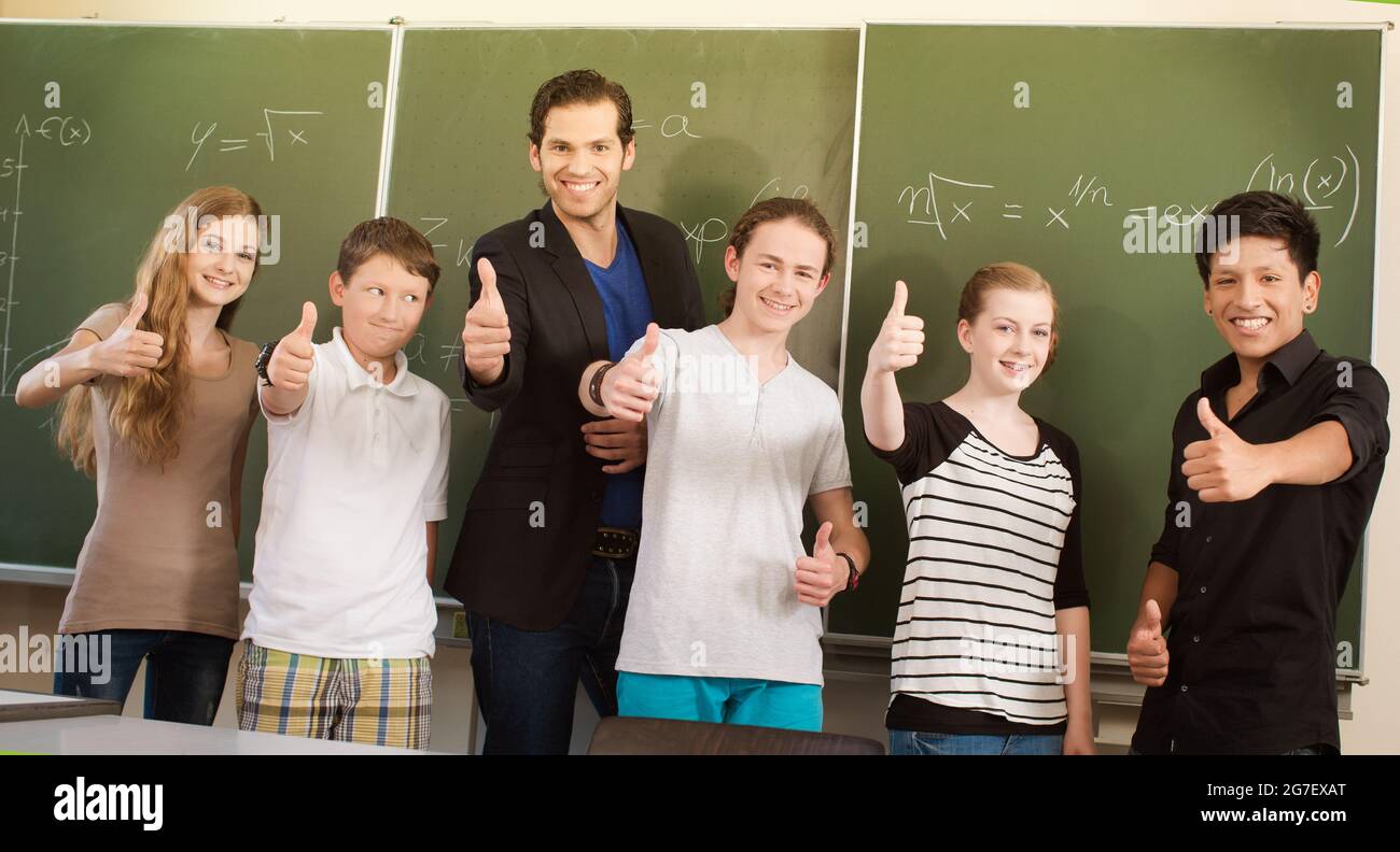 School and education - Teacher and students stand in front of a ...