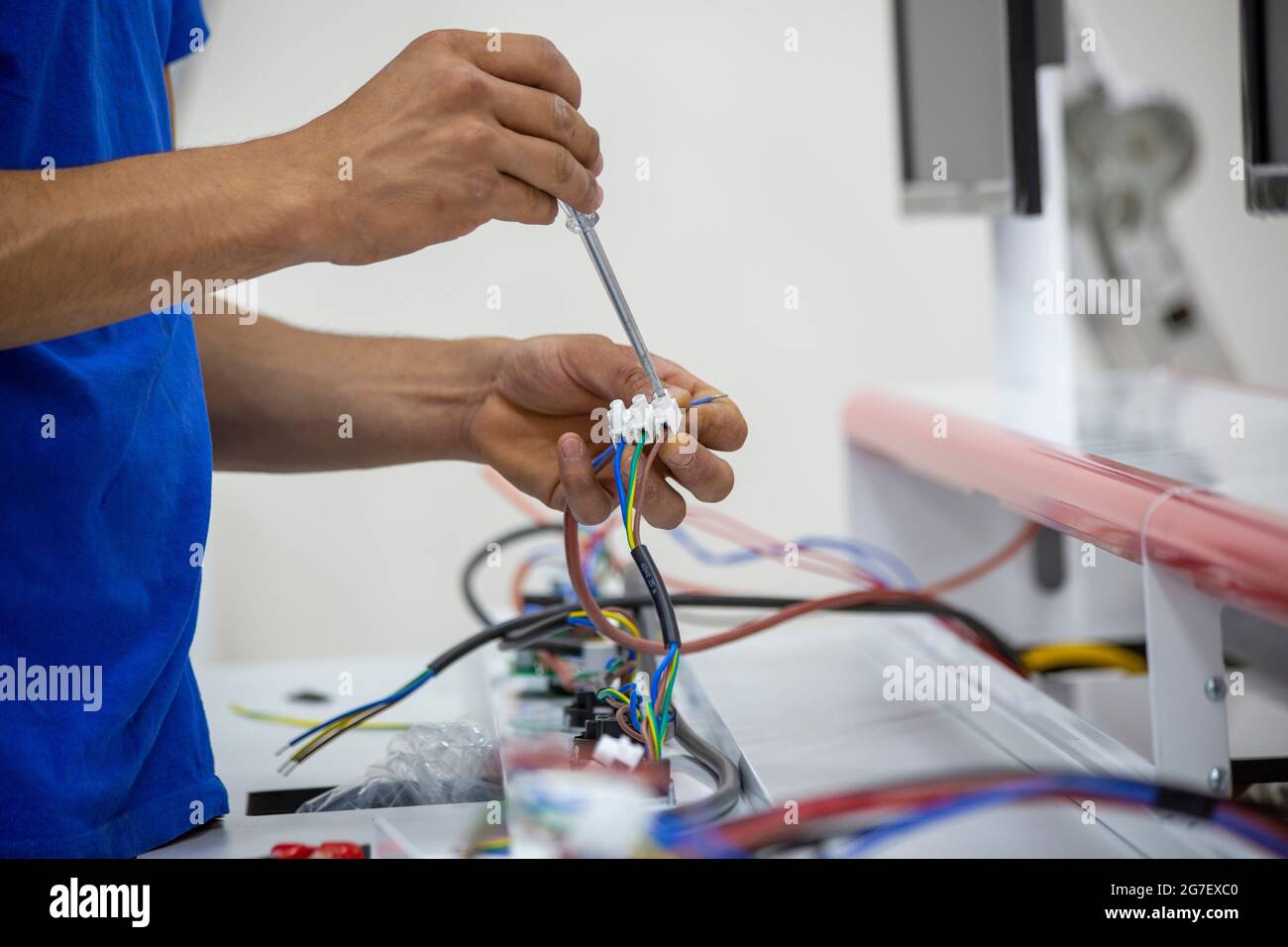 Master connecting electrical appliances. make a cable connection Stock ...