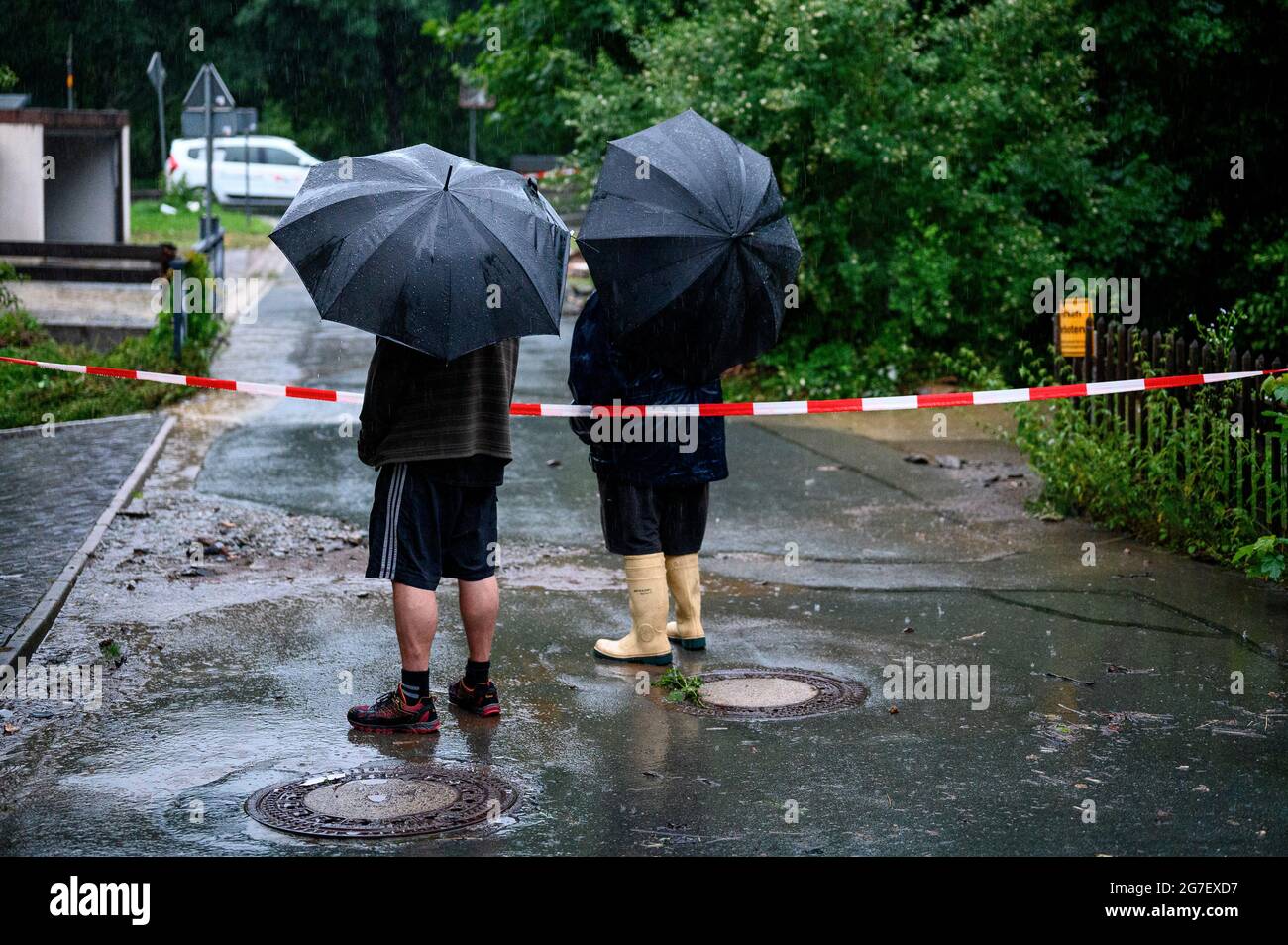 Naila, Germany. 13th July, 2021. Two residents look at the damage ...