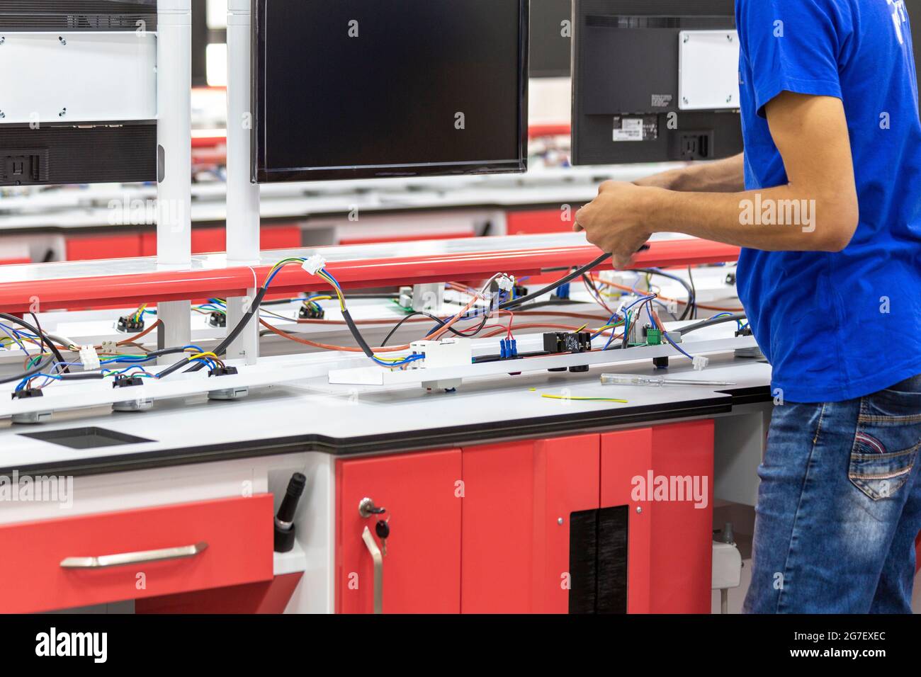 Master connecting electrical appliances. make a cable connection Stock ...