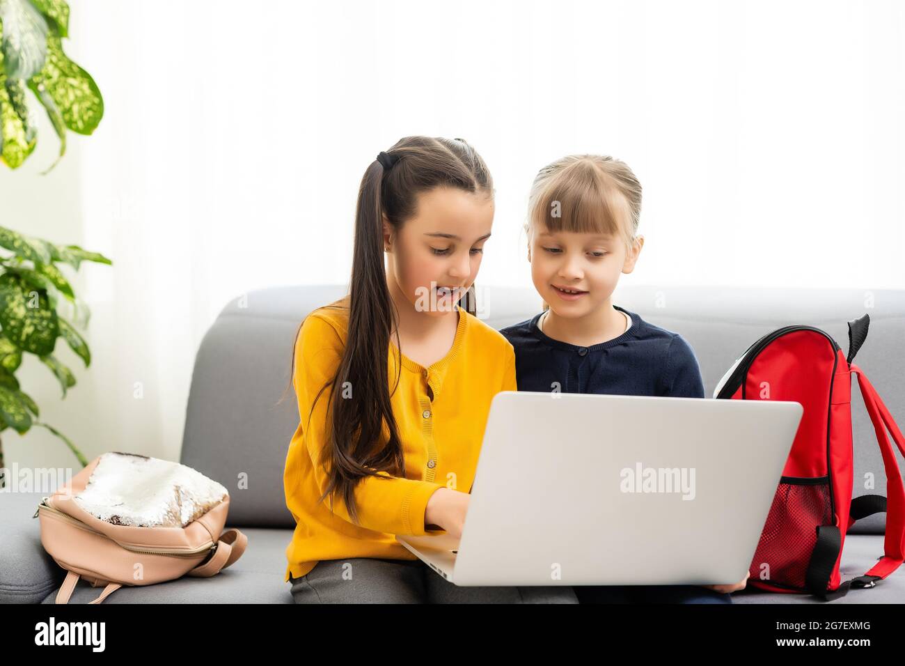 Cute girl friends laughing at laptop computer screen, hugging Stock ...