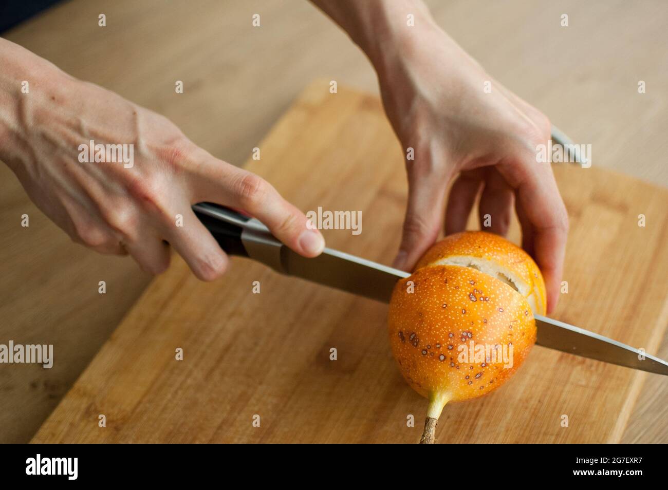 Fresh organic ripe granadilla or yellow passion fruit cut in half on a ...