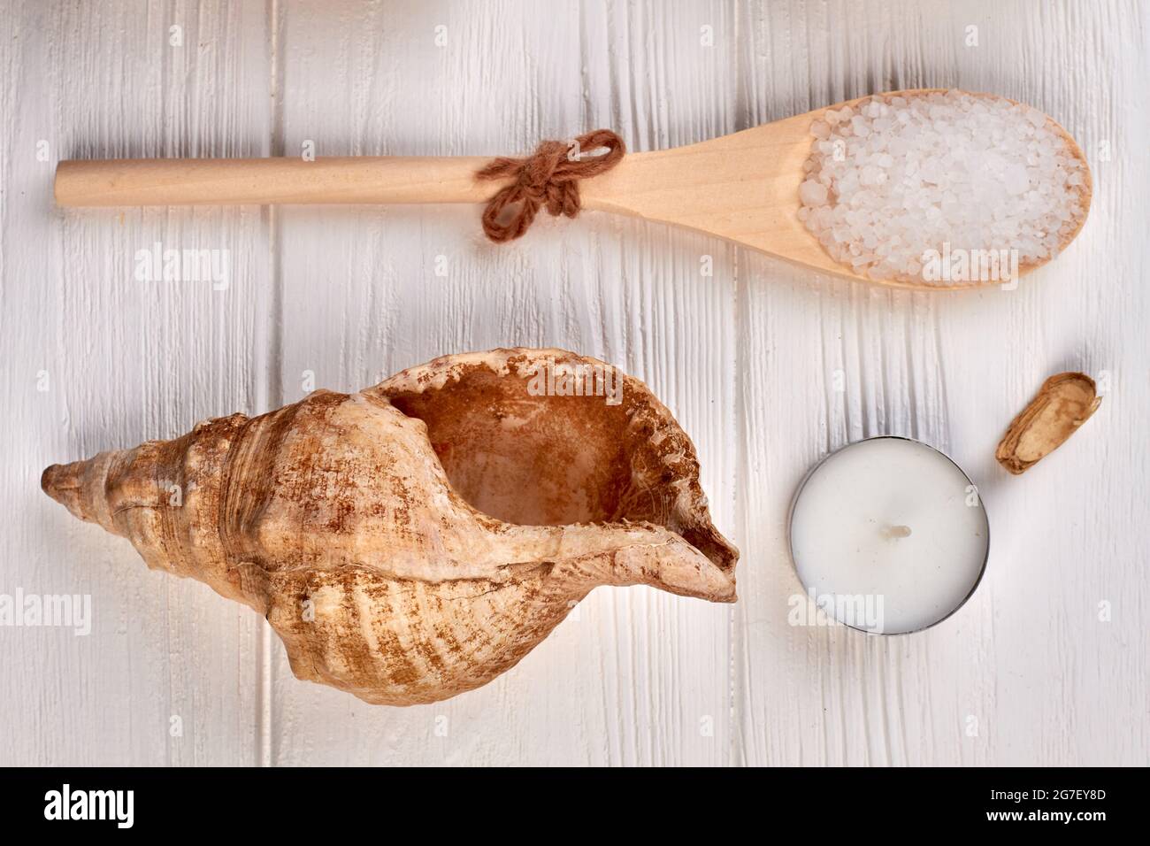 Spoon with seashell and candle top view flat lay Stock Photo - Alamy