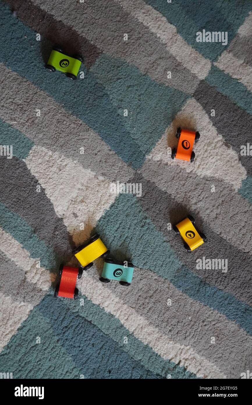 Top view of colourful small car models on a blue pattern carpet Stock ...