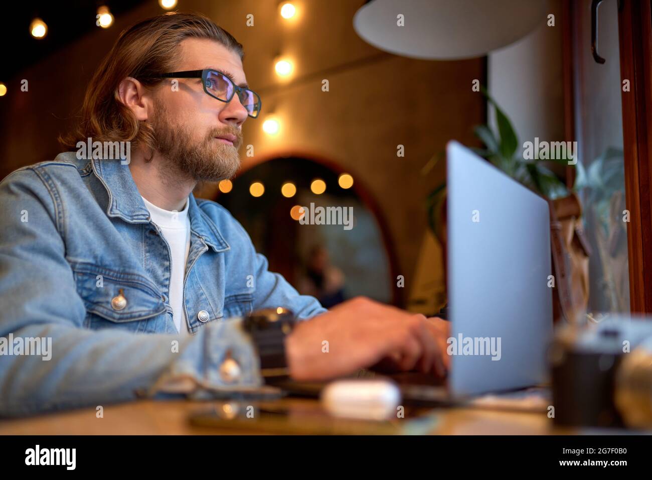 Side View Portrait Of Handsome Caucasian Guy In Denim Jacket Working On ...
