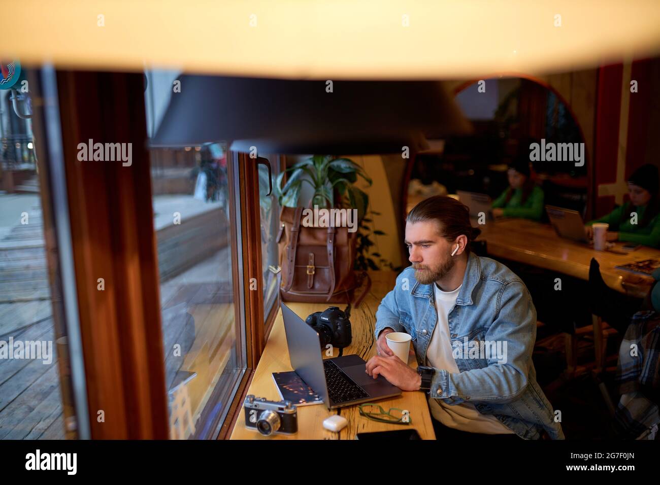 Side View Portrait Of Handsome Caucasian Guy In Denim Jacket Working On ...