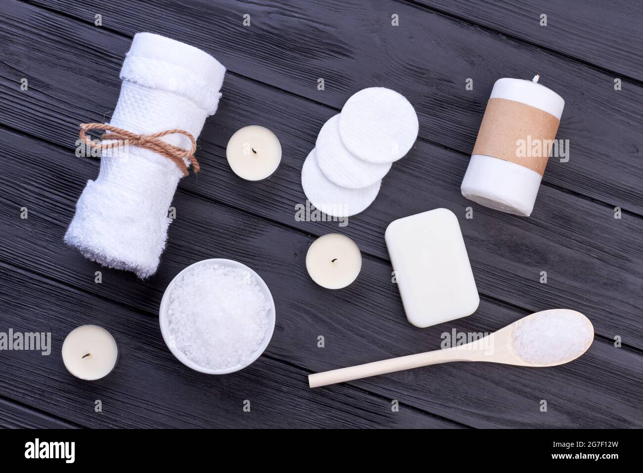 Flat lay white spa accessories on black background Stock Photo - Alamy