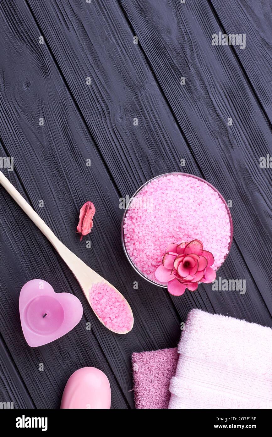 Pink bathroom spa accessories on dark wooden table Stock Photo - Alamy