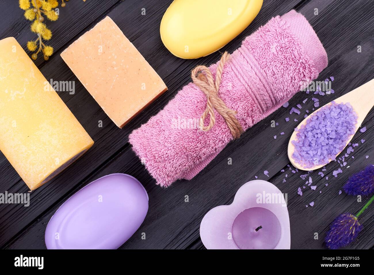 Rolled towel with soap pieces and candle top view Stock Photo - Alamy