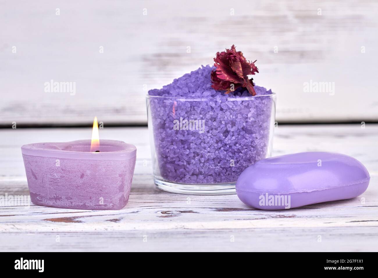 Purple salt with soap and candle on white background Stock Photo - Alamy