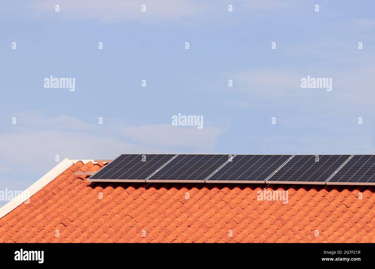 Solar photovoltaic panels on a roof at sunset. Clean energy modern ...