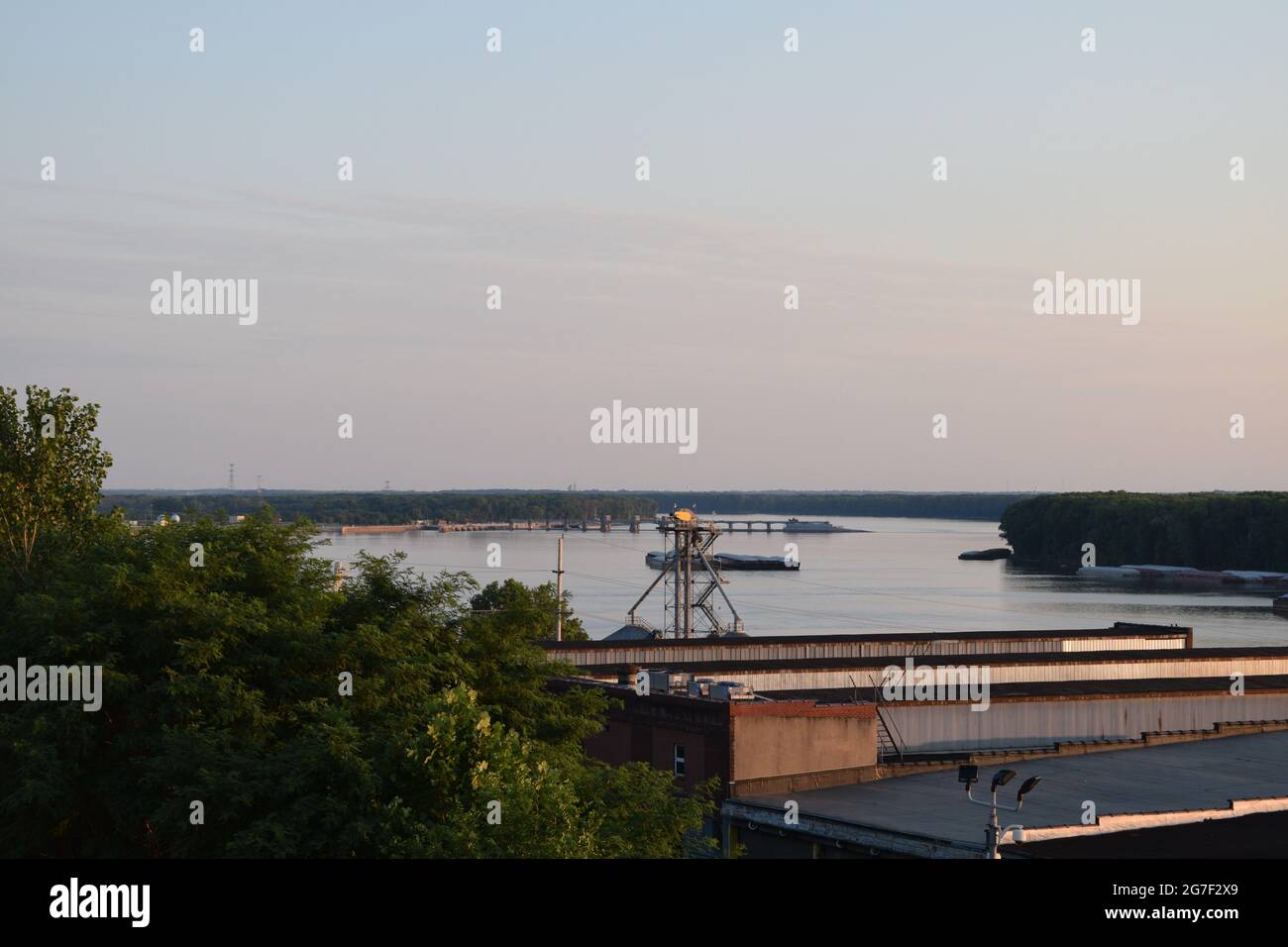Mississippi River with barges at sunset Stock Photo - Alamy
