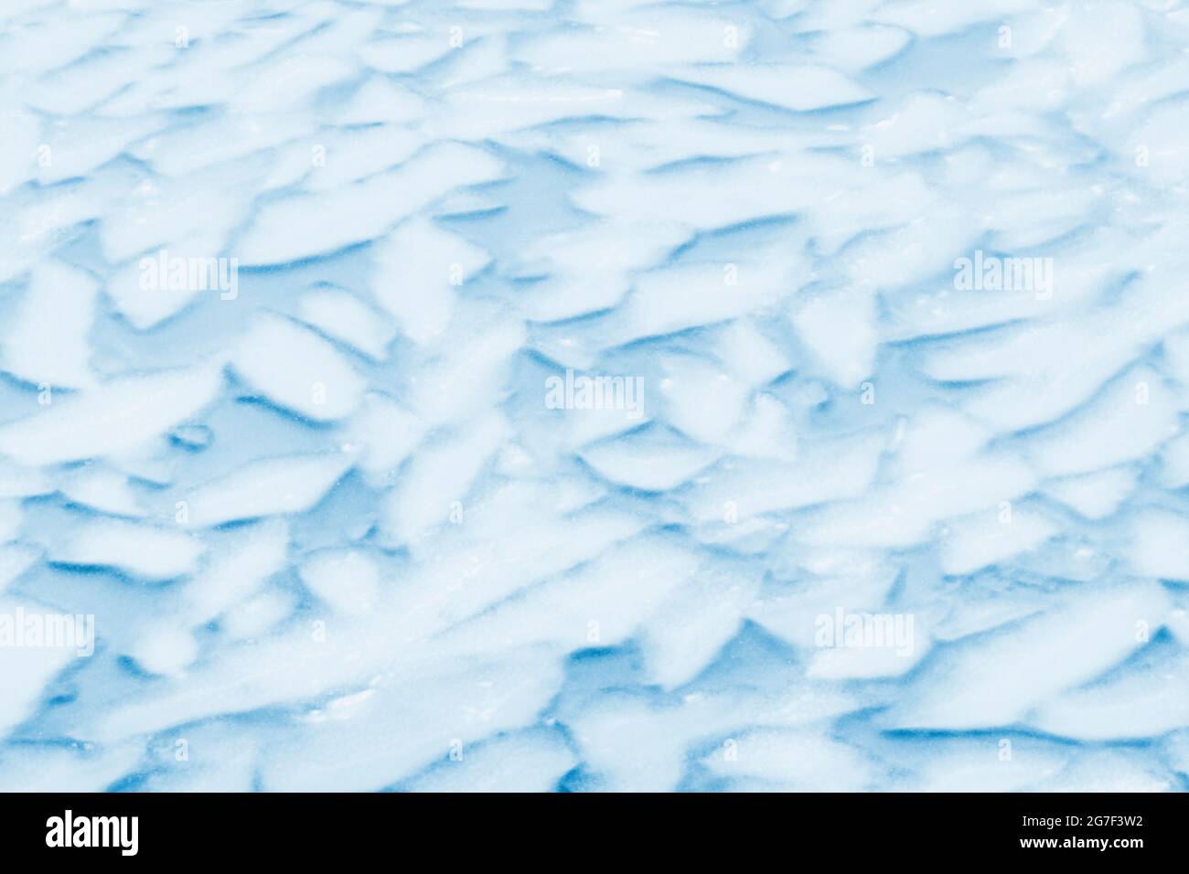 Blue cracked ice on the winter lake surface. Top view Stock Photo - Alamy