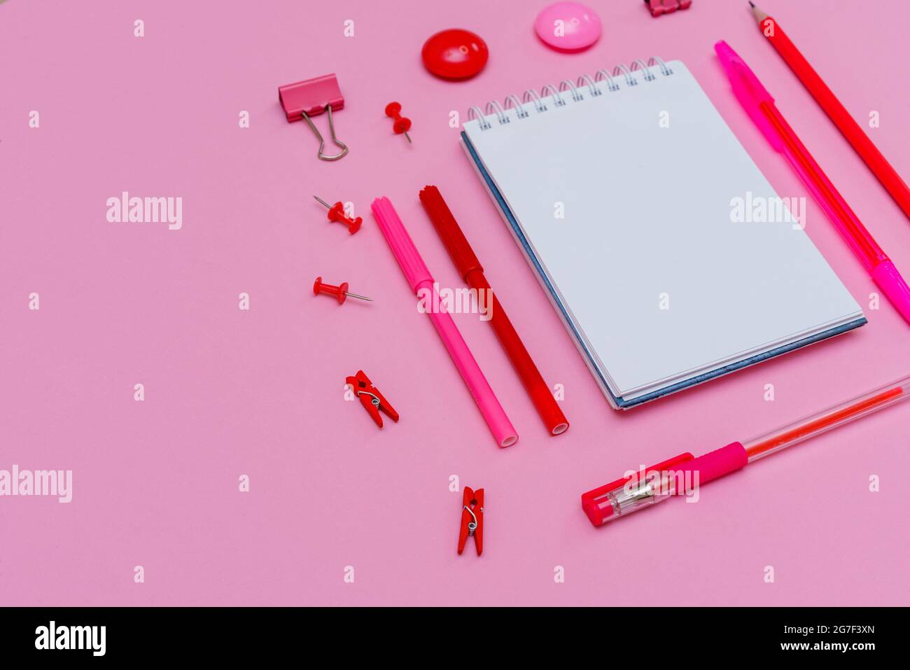 Stationery in pastel pink shades. On a pink background, flat lay ...