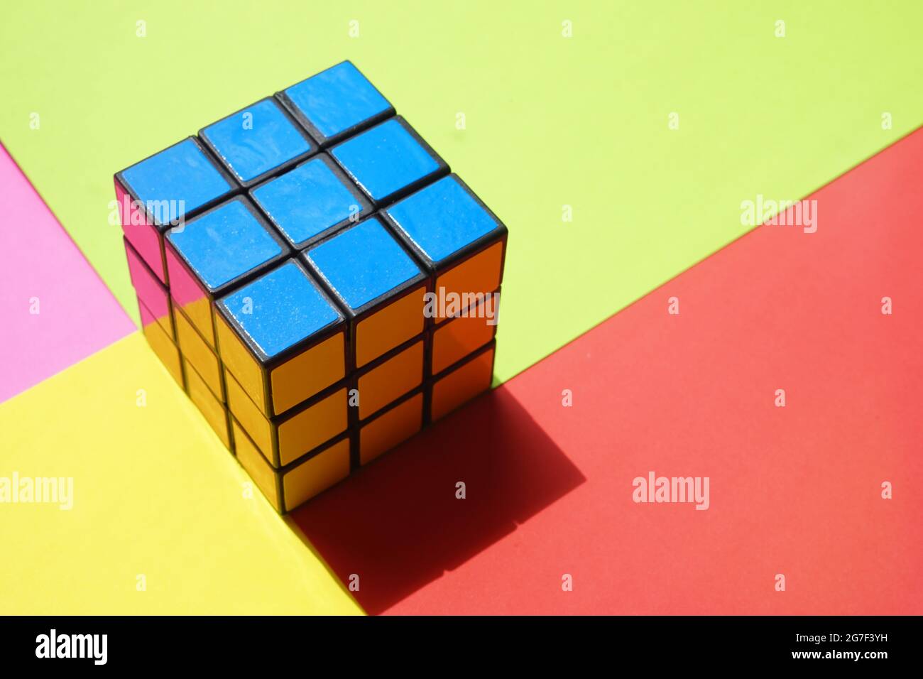 Rubik's cube toy on a multicolored table Stock Photo - Alamy
