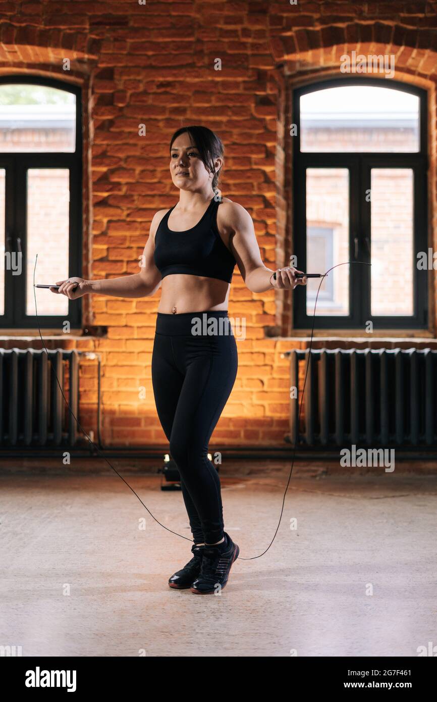 Vertical shot of fitness young athletic woman with strong beautiful ...