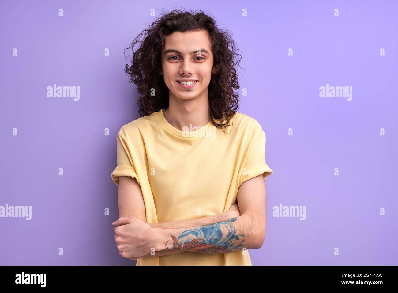 Calm smiling male with arms folded, looking at camera confidently, copy ...