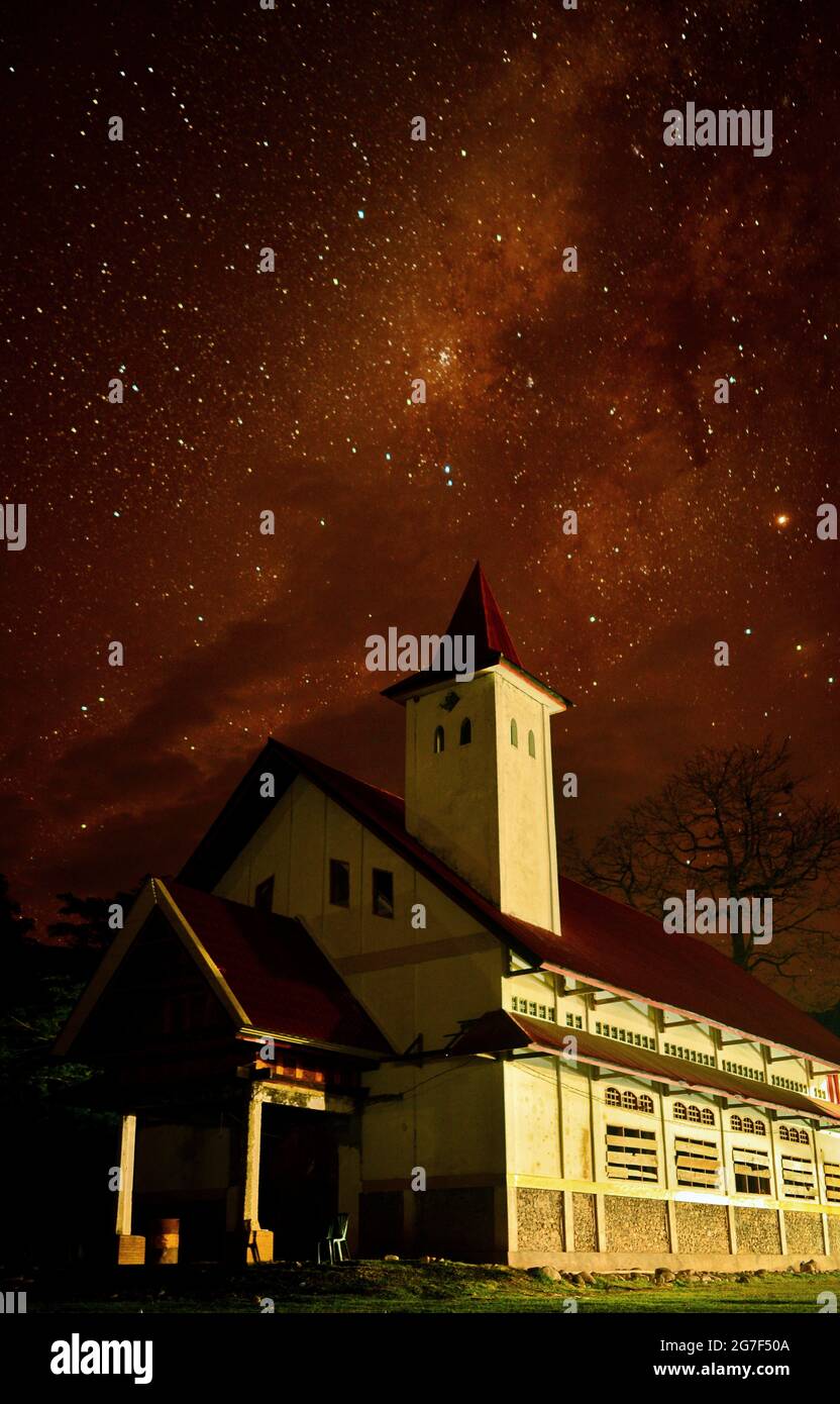 White building with a red roof on a starry night sky Stock Photo - Alamy