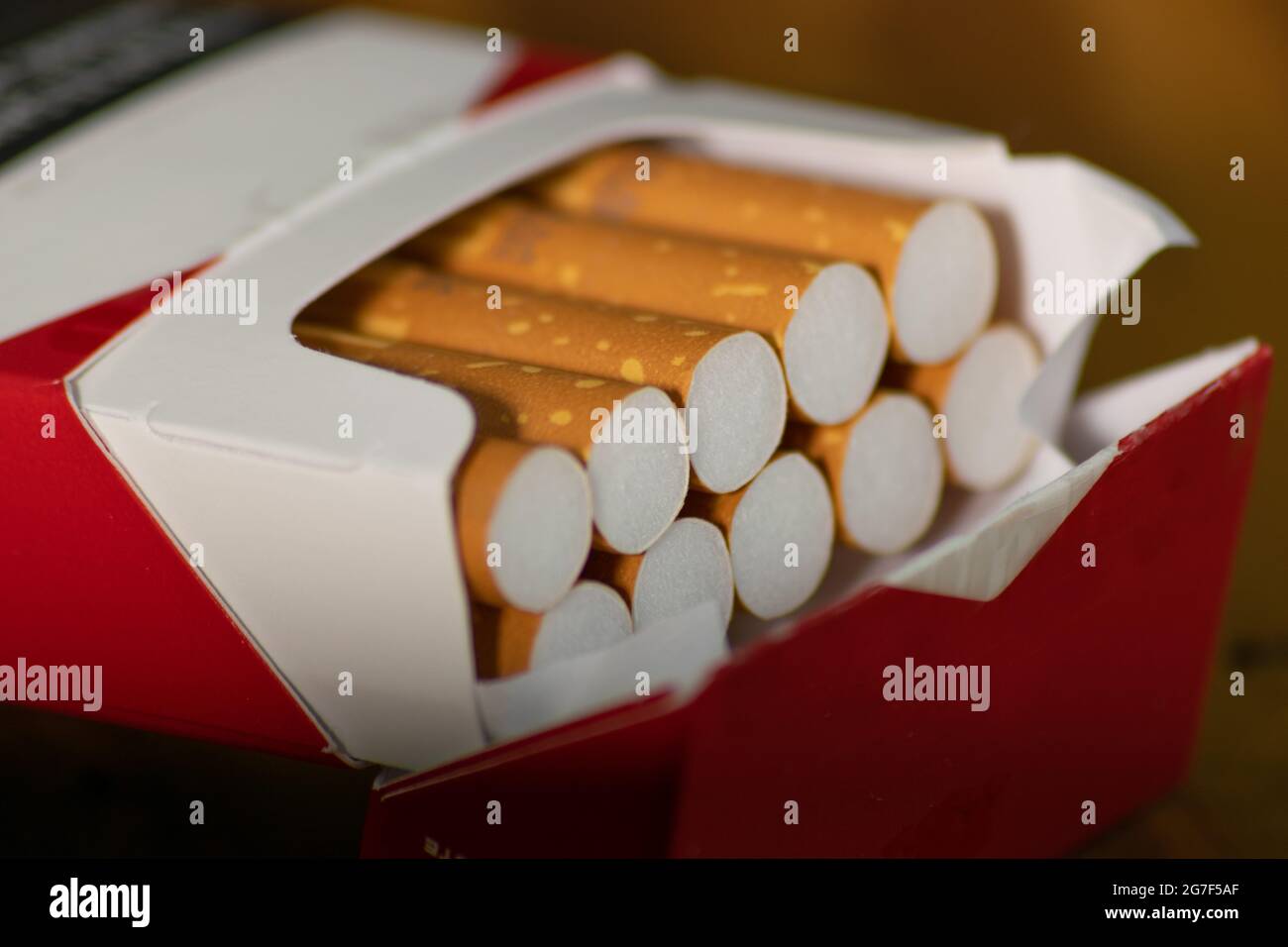 Open cigarette bundle of ten full cigarettes from very close range ...