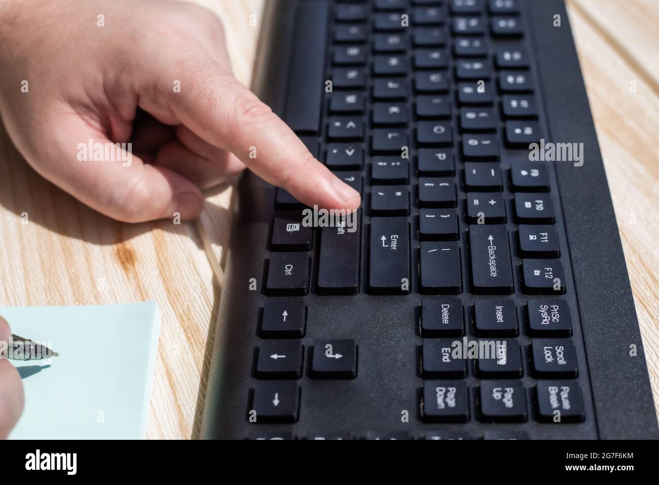 Hands Pressing Computer Keyboard Keys While Writing With Pencil In ...
