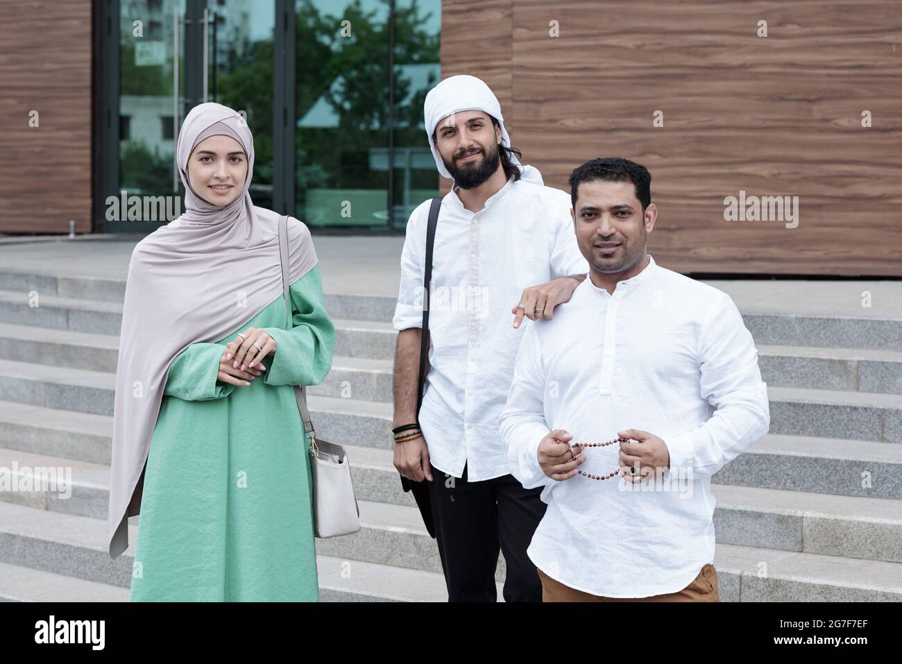 Group Of young Muslim colleagues standing together against modern ...