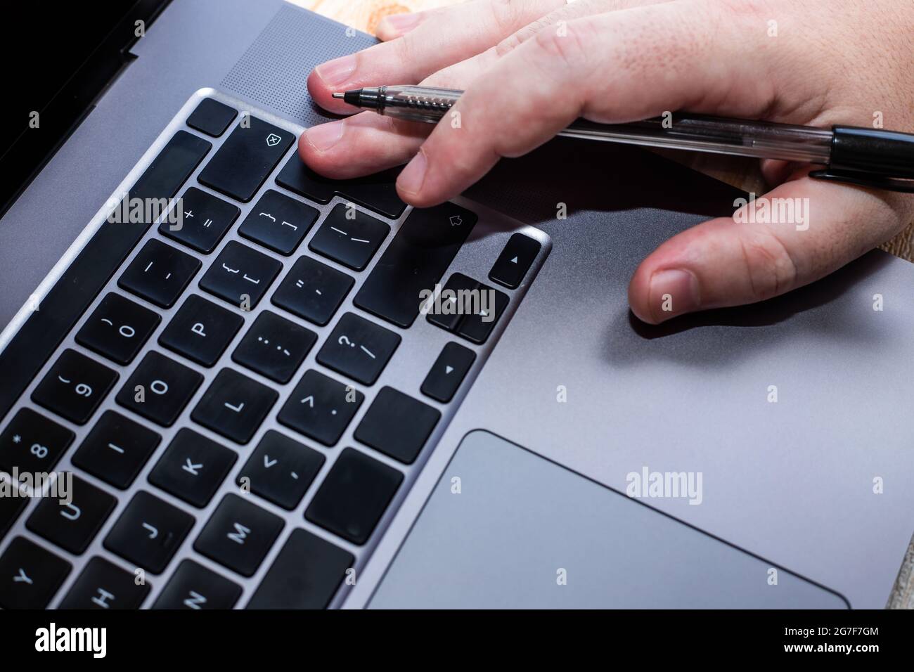Hands Pressing Computer Keyboard Keys While Writing With Pencil In ...