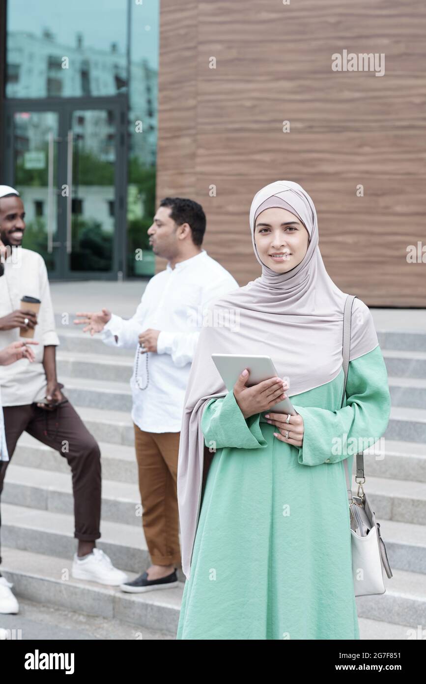 Portrait of modern young Islamic woman in hijab and national dress ...