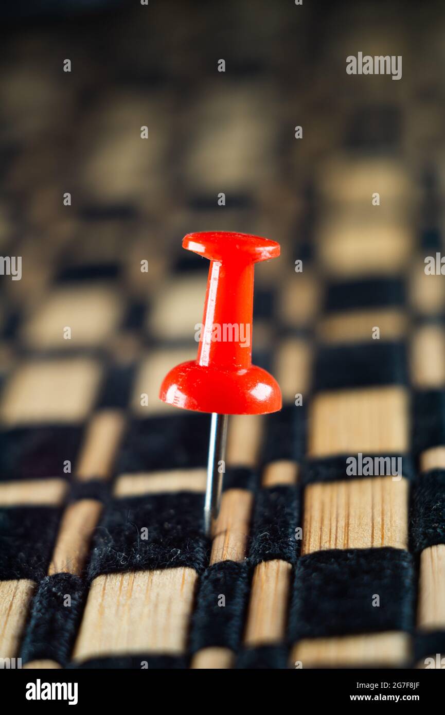 Selective focus of a red push pin fixed in a surface Stock Photo - Alamy