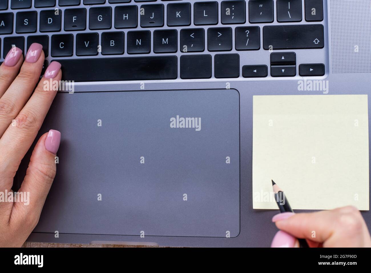 Hands Pressing Computer Keyboard Keys While Writing With Pencil In ...