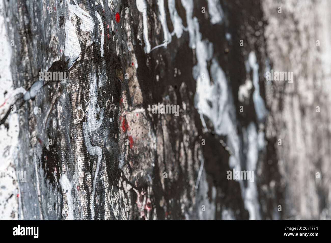 Closeup image of a textured white wall with black, white, and red line ...