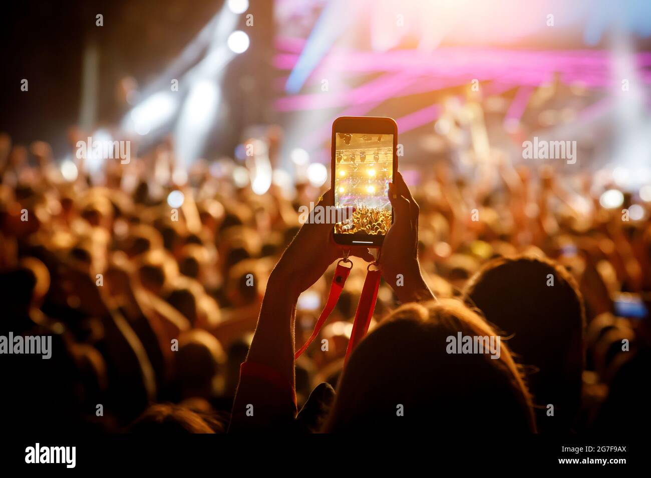 Using a mobile phone at the concert Stock Photo - Alamy