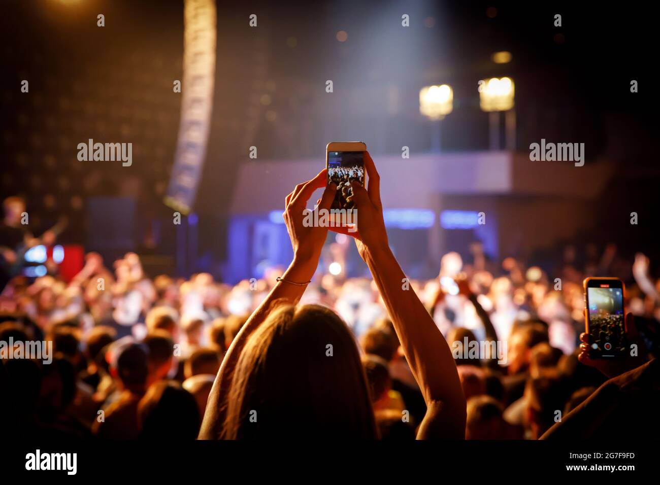 Using a mobile phone at the concert Stock Photo - Alamy