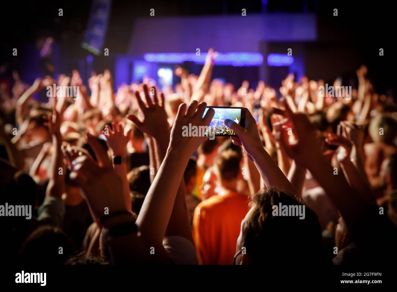 Using a mobile phone at the concert Stock Photo - Alamy