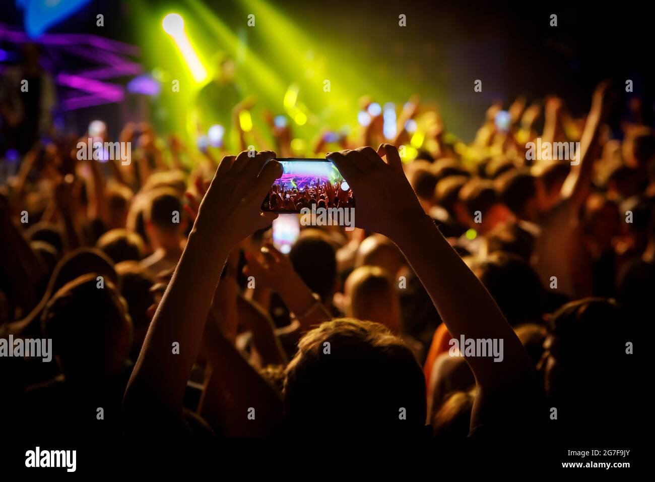 Using a mobile phone at the concert Stock Photo - Alamy