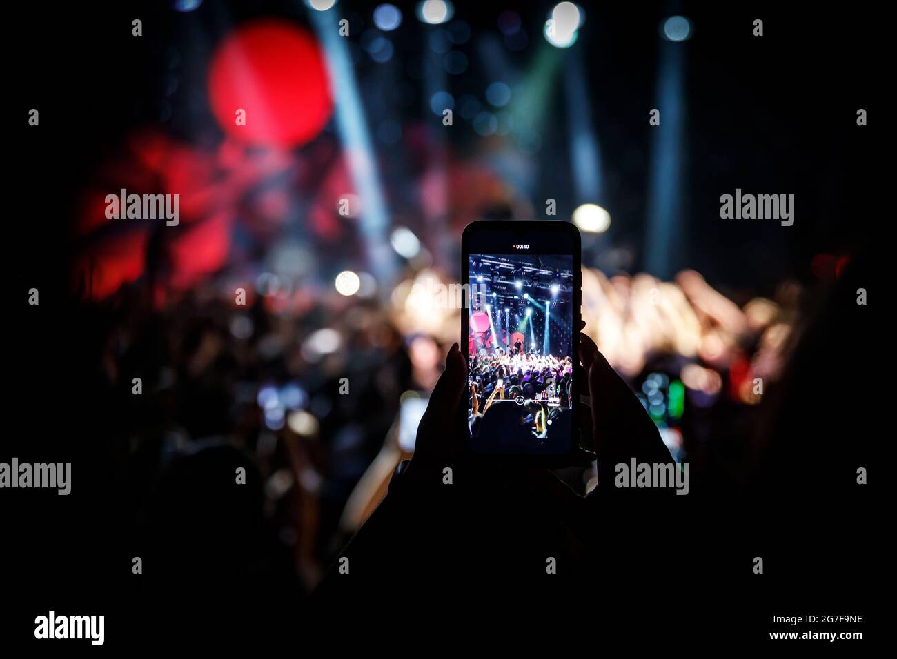 Using a mobile phone at the concert Stock Photo - Alamy
