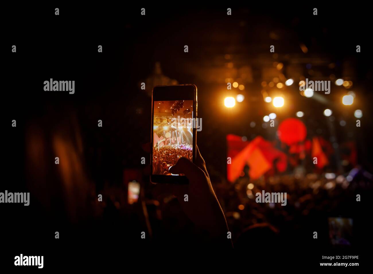 Using a mobile phone at the concert Stock Photo - Alamy