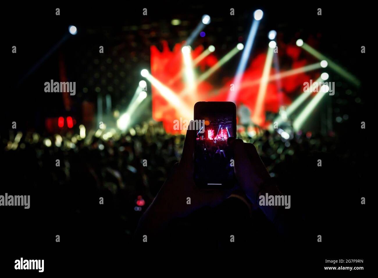 Using a mobile phone at the concert Stock Photo - Alamy