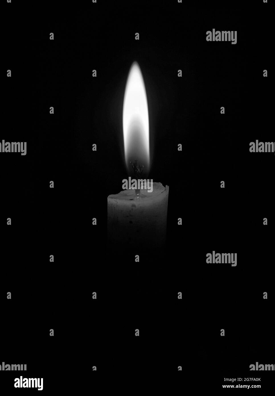Grayscale of a burning white candle in the darkness Stock Photo - Alamy