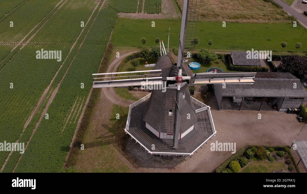 Aerial of iconic mill construction in countryside in The Netherlands ...