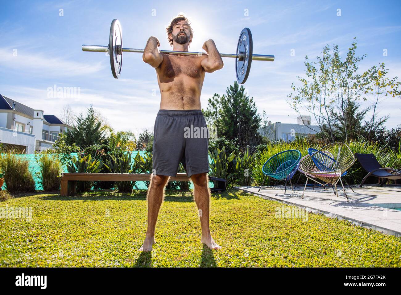 Middle age man training crossfit and weightlifting in his backyard ...