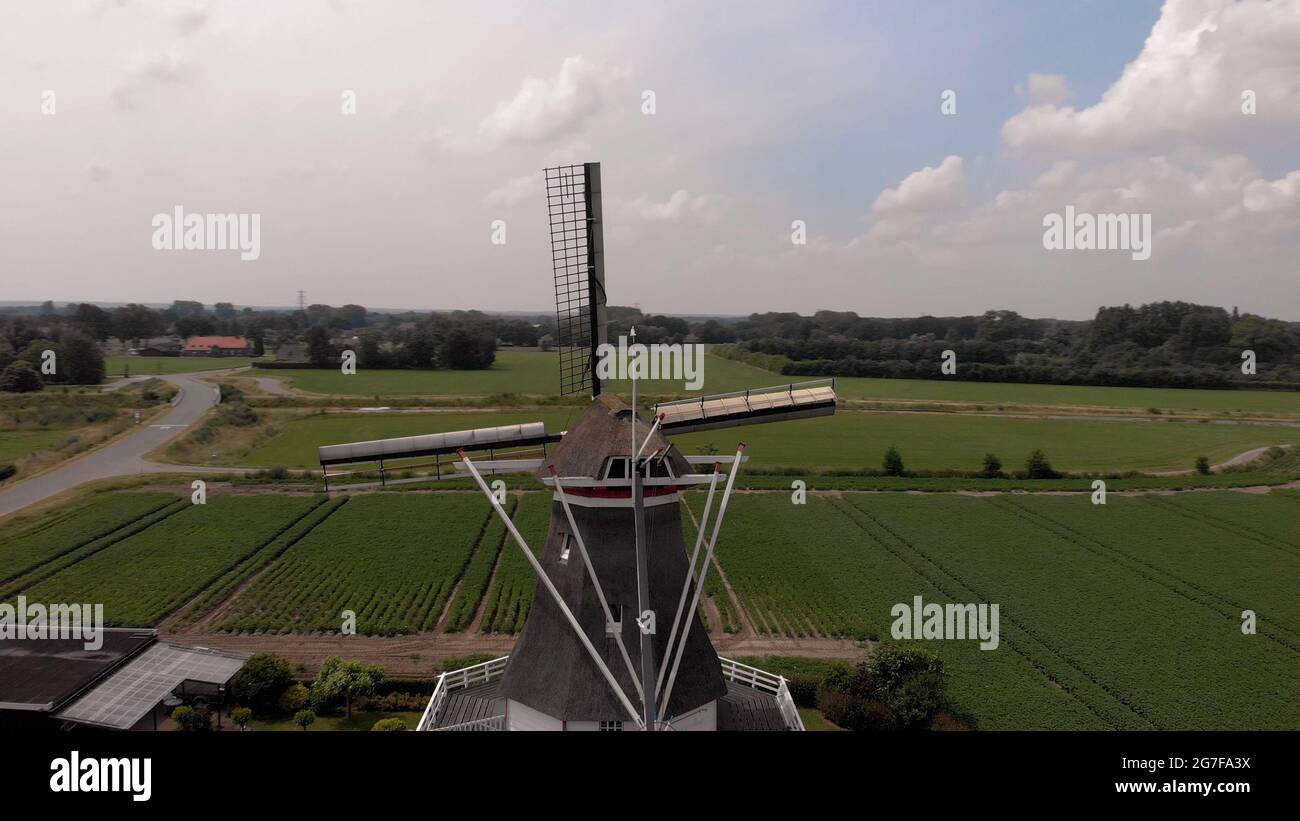 Aerial of iconic mill construction in countryside in The Netherlands ...