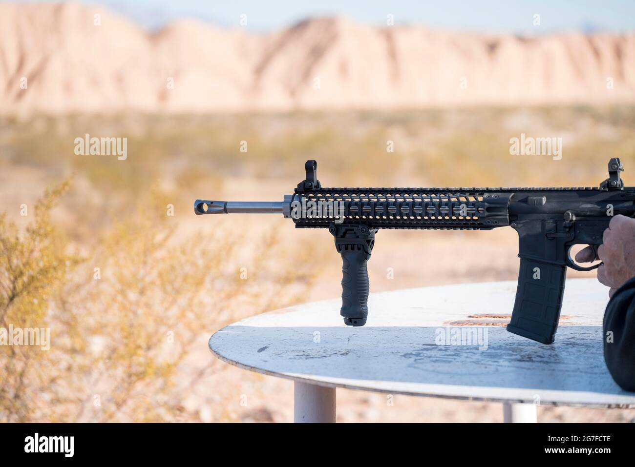 Black ar and rifle aiming on the left side with a blurry background of ...