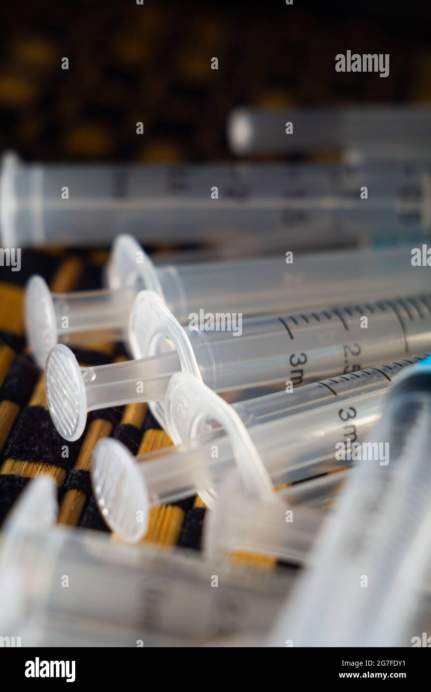 Vertical closeup shot of a pile of medical syringes Stock Photo - Alamy