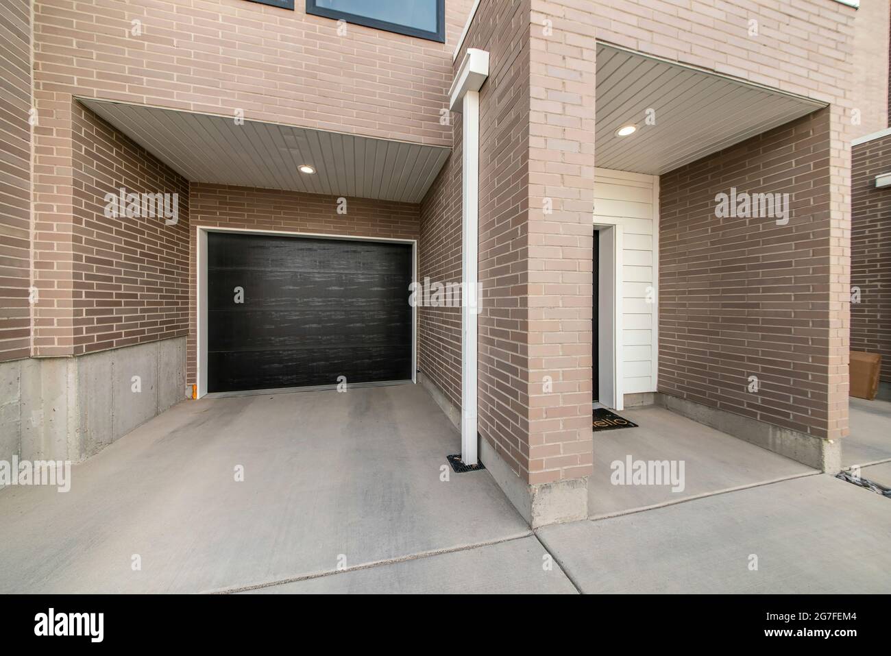 Townhouse garage exterior with smooth brown bricks Stock Photo - Alamy