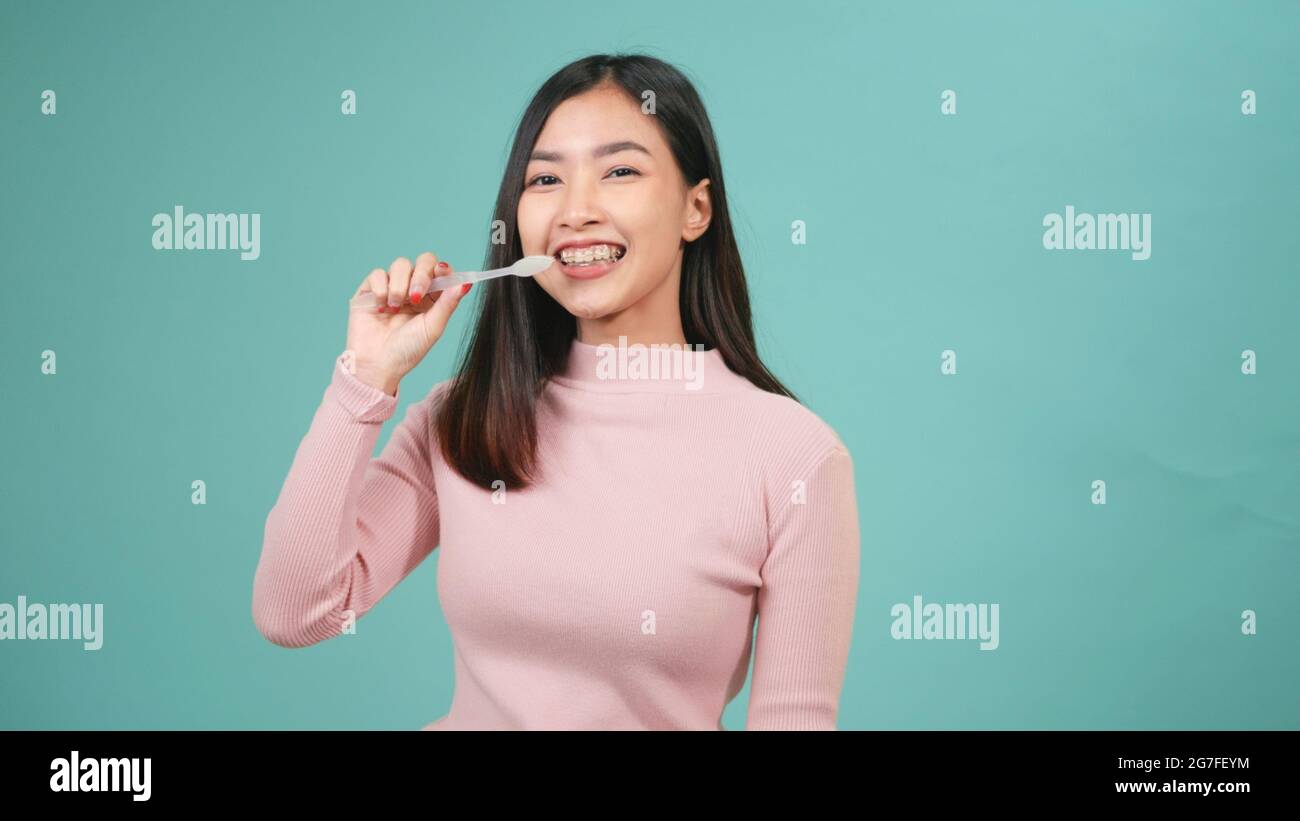 Asian young beautiful woman smile brushing teeth dancing enjoying music ...